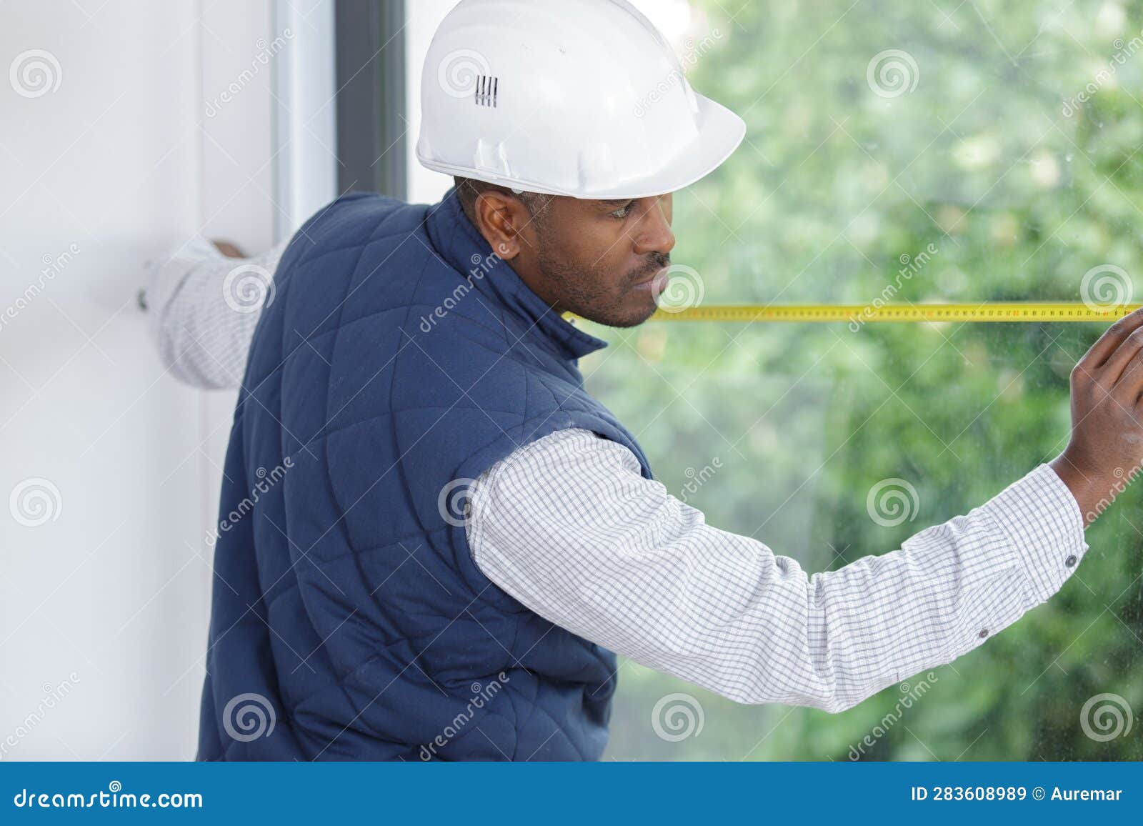Construction Worker Using Measuring Tape in New House Stock Image ...