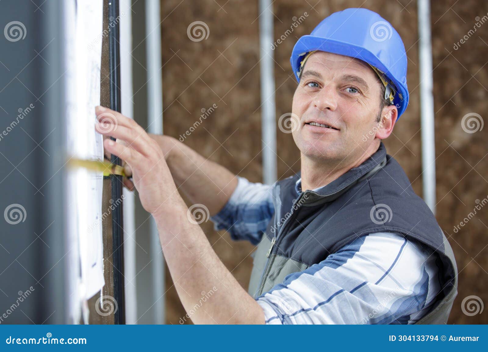 Construction Worker Using Measuring Tape in New House Stock Photo ...