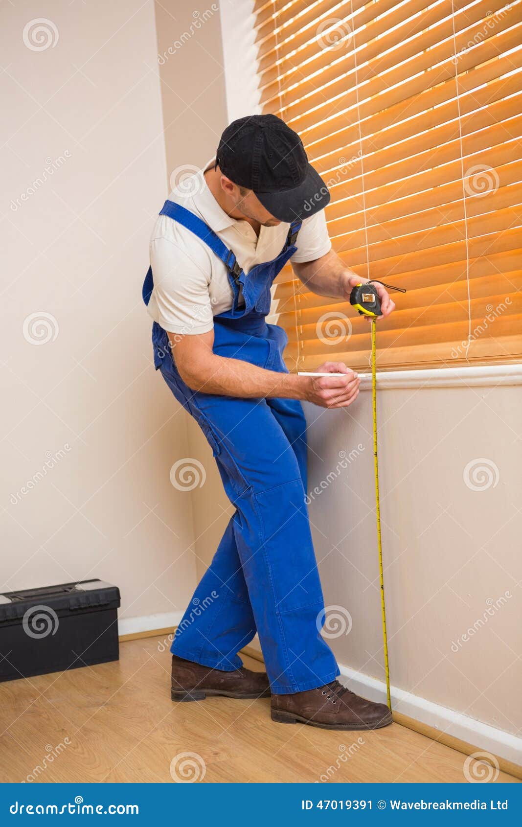 Construction Worker Using Measuring Tape Stock Image - Image of male ...