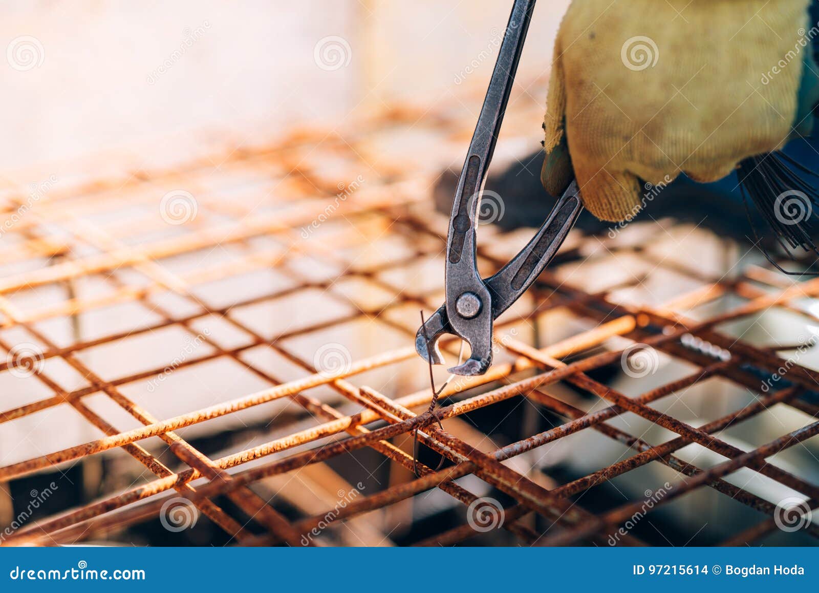 Construction Worker Using Pliers And Securing Steel Bars With Wire Rod ...