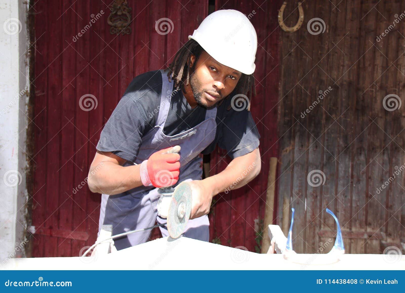 A Construction Worker Using a Power Cut Machine Stock Photo - Image of ...