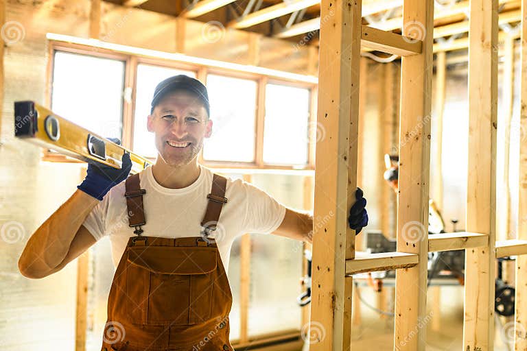 Construction Worker Using Power Tool in Unfinished Basement of New Home Stock Image - Image of ...