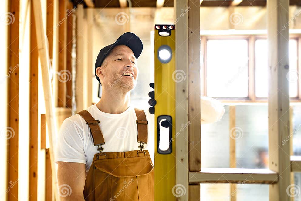 Construction Worker Using Power Tool in Unfinished Basement of New Home Stock Photo - Image of ...