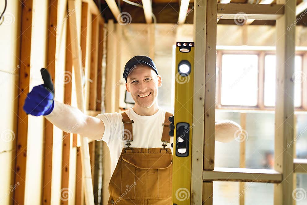 Construction Worker Using Power Tool in Unfinished Basement of New Home Stock Photo - Image of ...