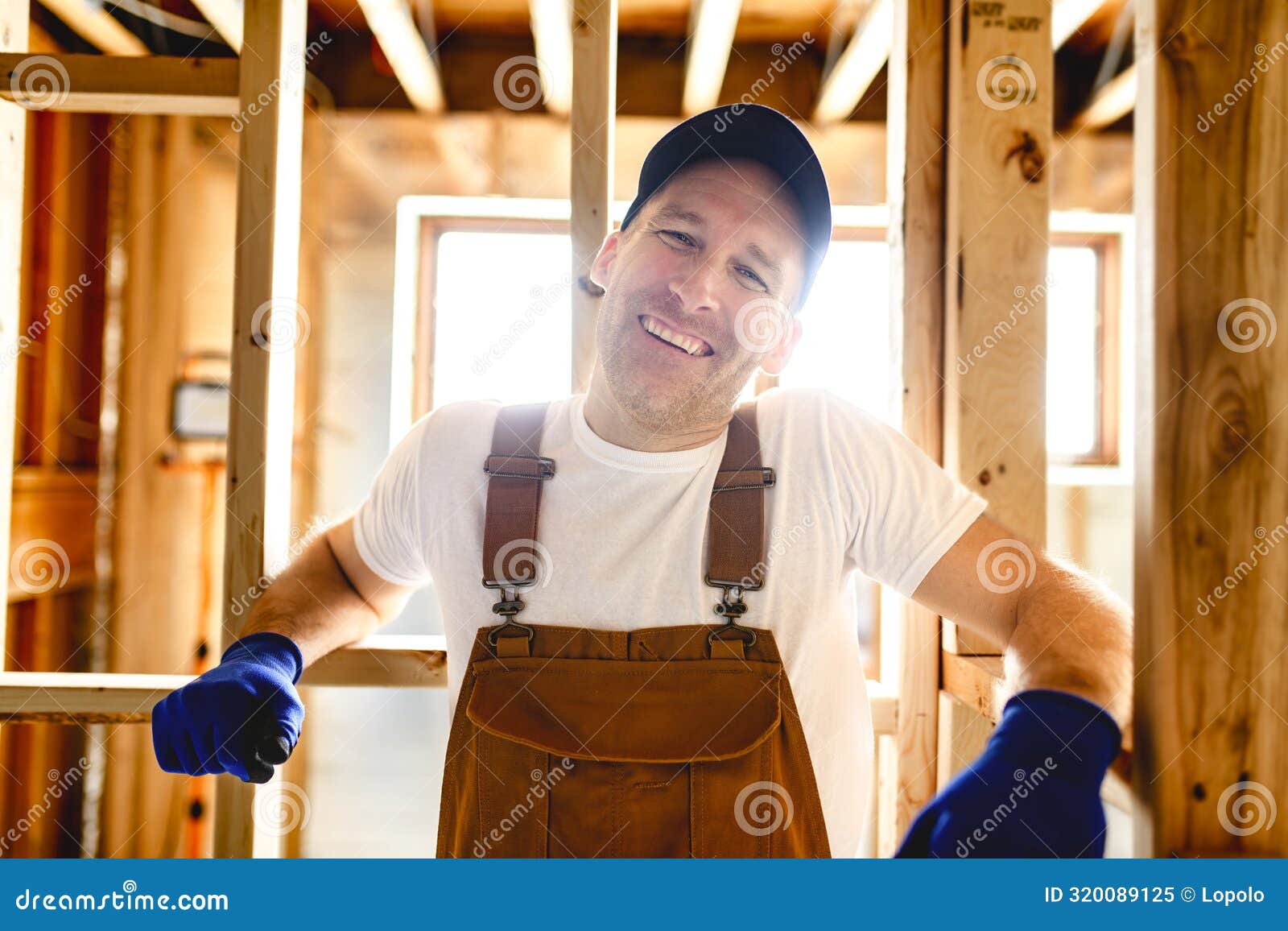 Construction Worker Using Power Tool in Unfinished Basement of New Home ...