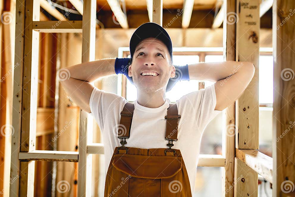 Construction Worker Using Power Tool in Unfinished Basement of New Home Stock Photo - Image of ...