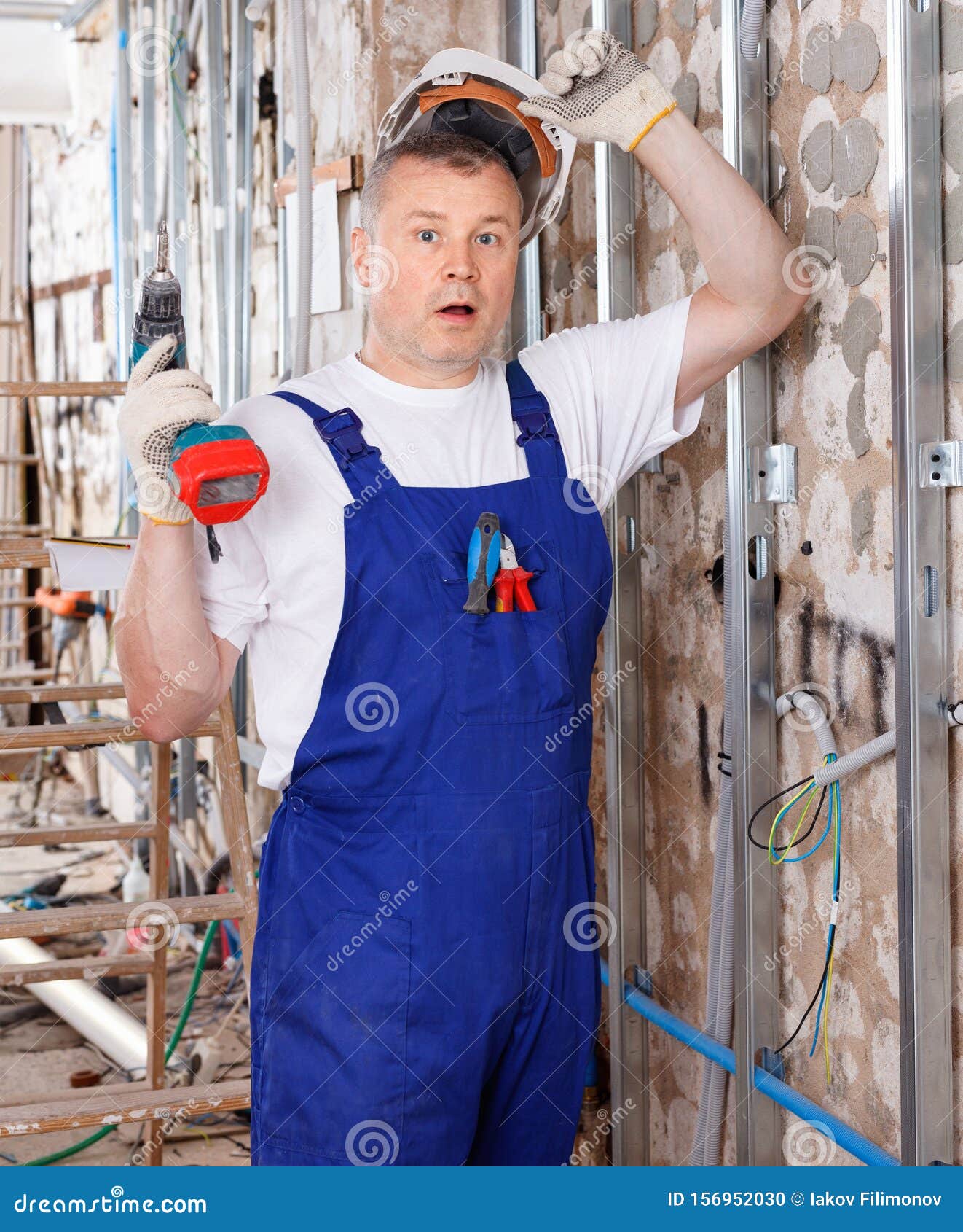 Construction Worker Using Gun for Aluminum Profile Mounting at Indoors ...
