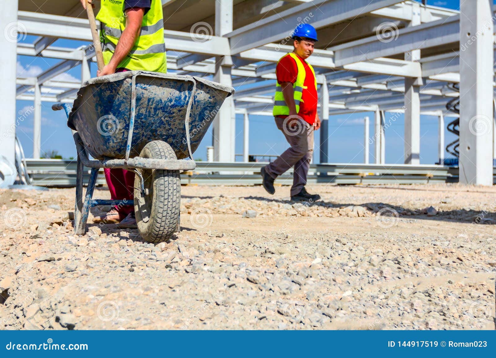 Worker is Using Shovel Unload Wheelbarrow at Building Site Editorial ...