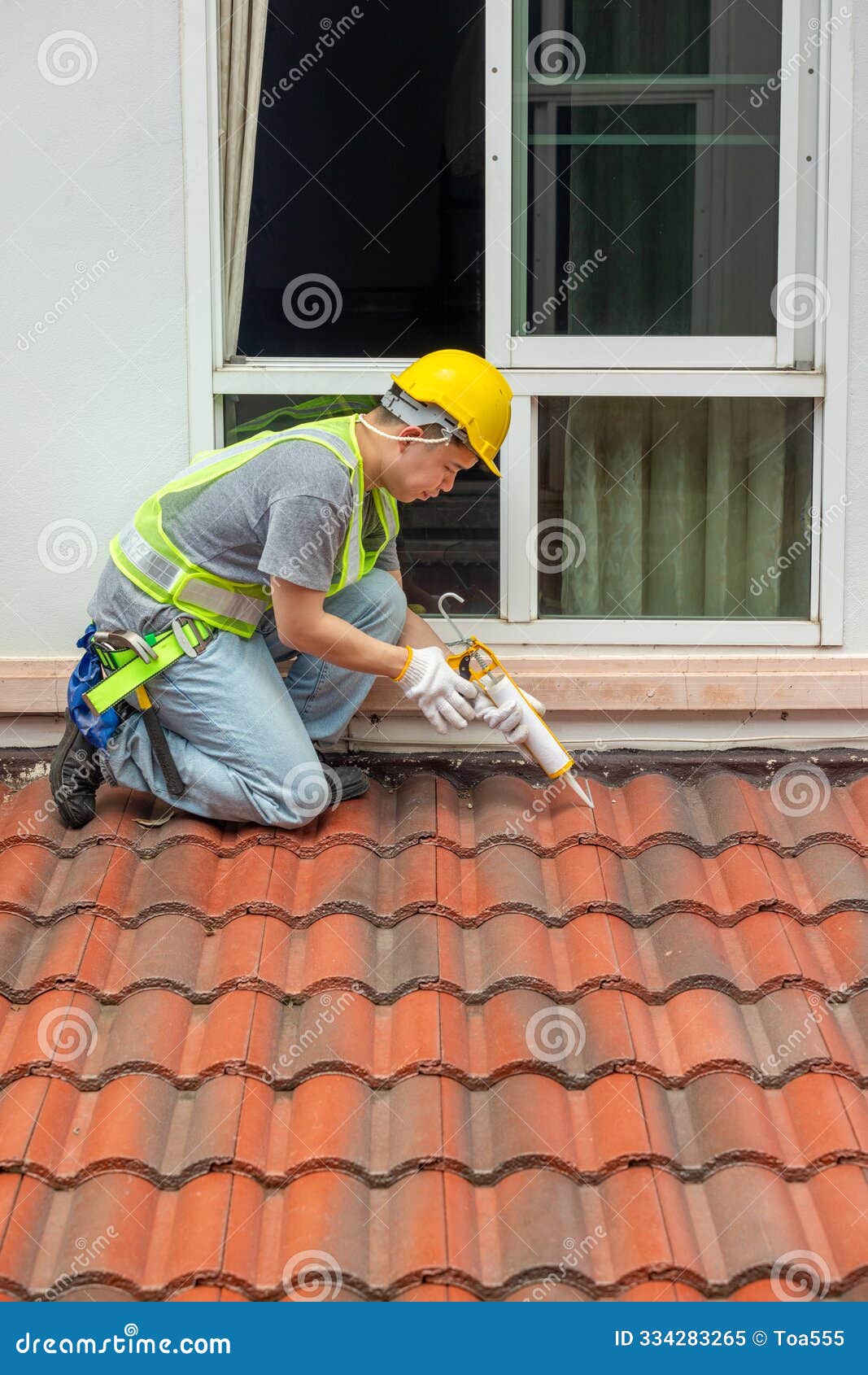 Construction Worker Using Silicone Sealant Adhesive To Fix Crack of the ...
