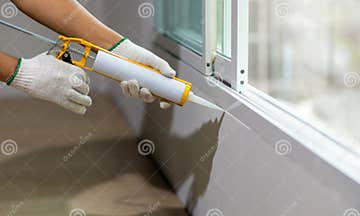 Construction Worker Using Silicone Sealant Caulk the Outside Window ...