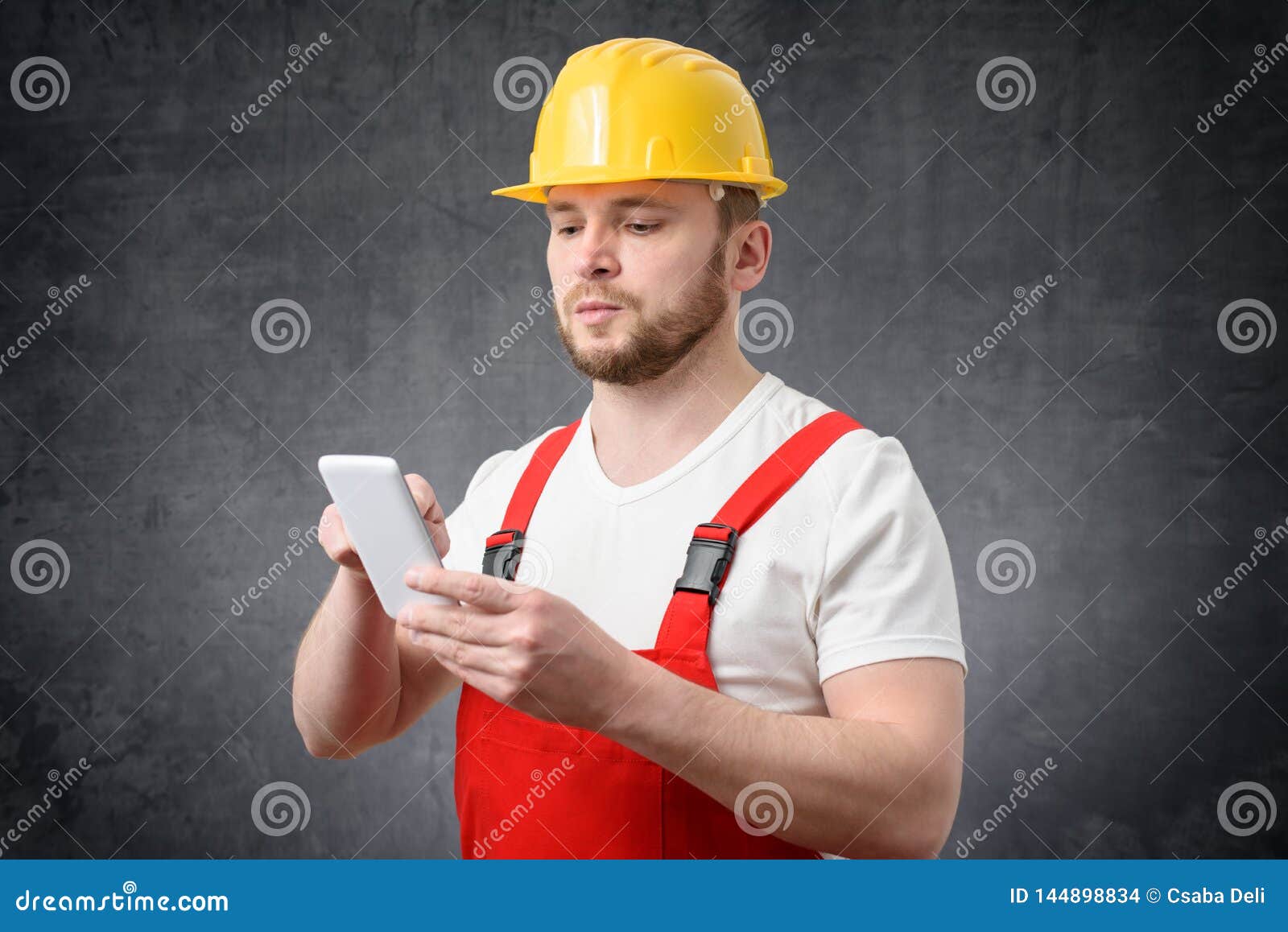 Construction Worker Using Smartphone Stock Photo - Image of looking ...