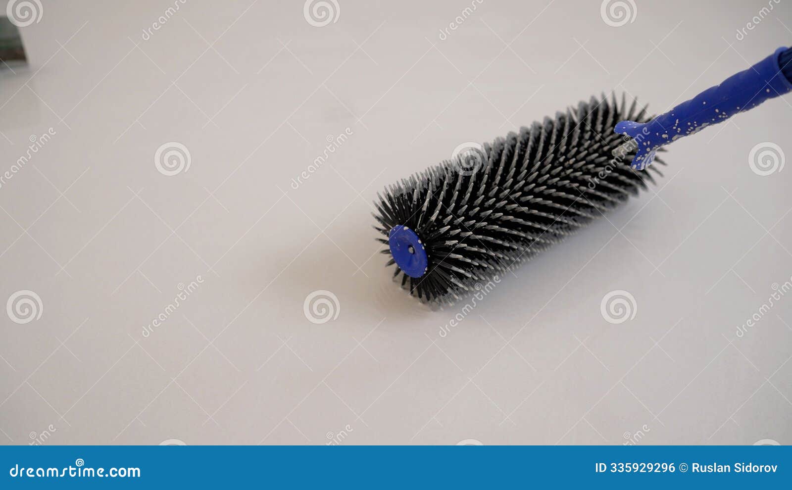 Construction Worker Using a Spiked Roller To Level the Floor. Stock ...