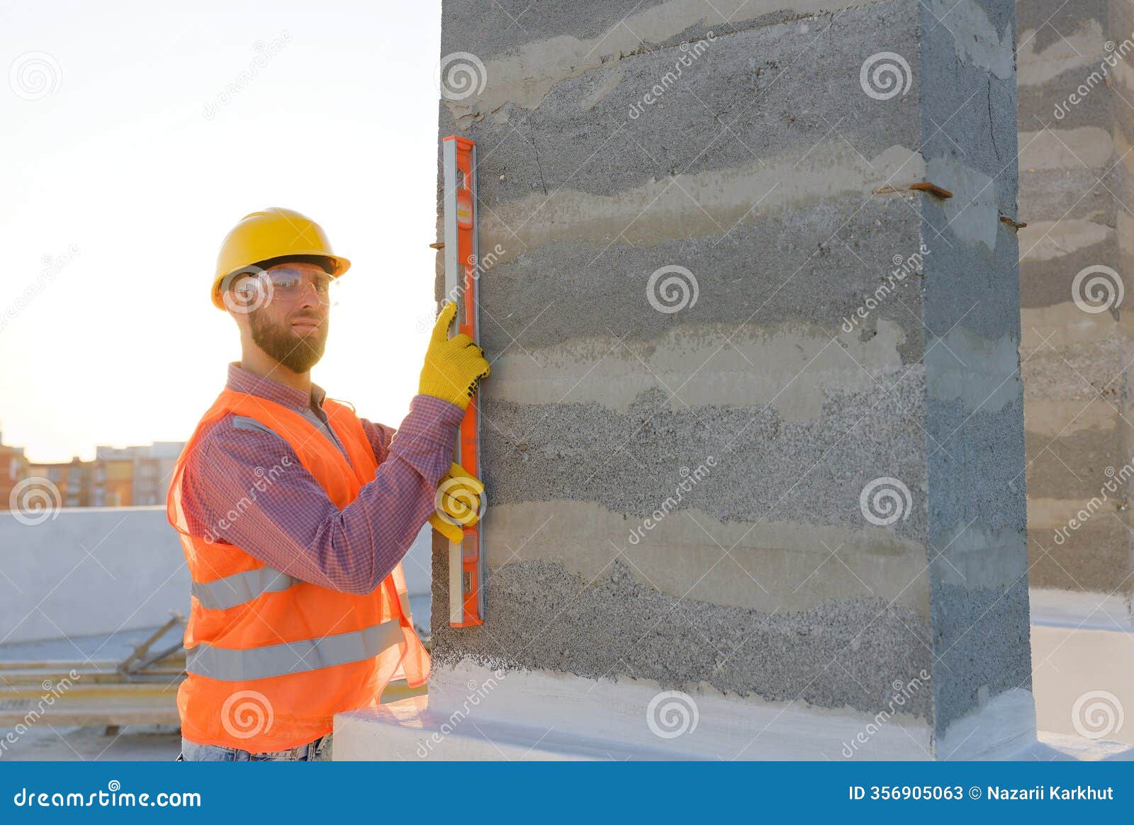 Construction Worker Using Spirit Level on Building Site at Sunset Stock ...