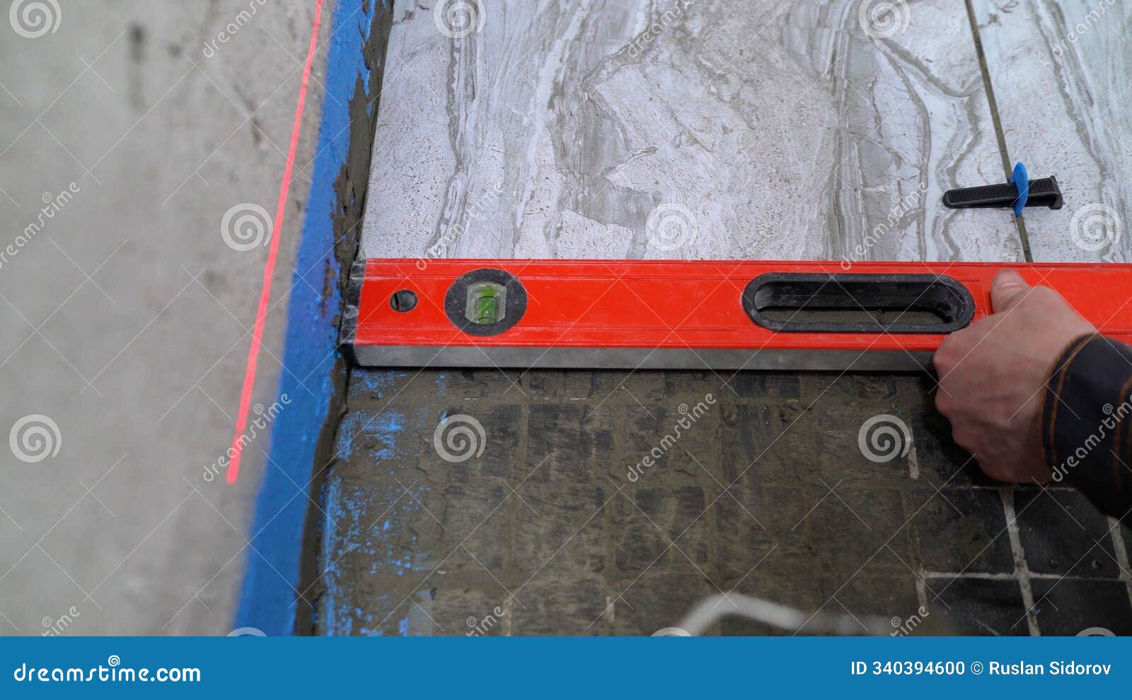 Construction Worker Using Spirit Level while Laying Tile. Stock Photo ...