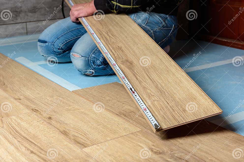 Construction Worker Using Tape Measure Ruler Measuring Laminate Board ...