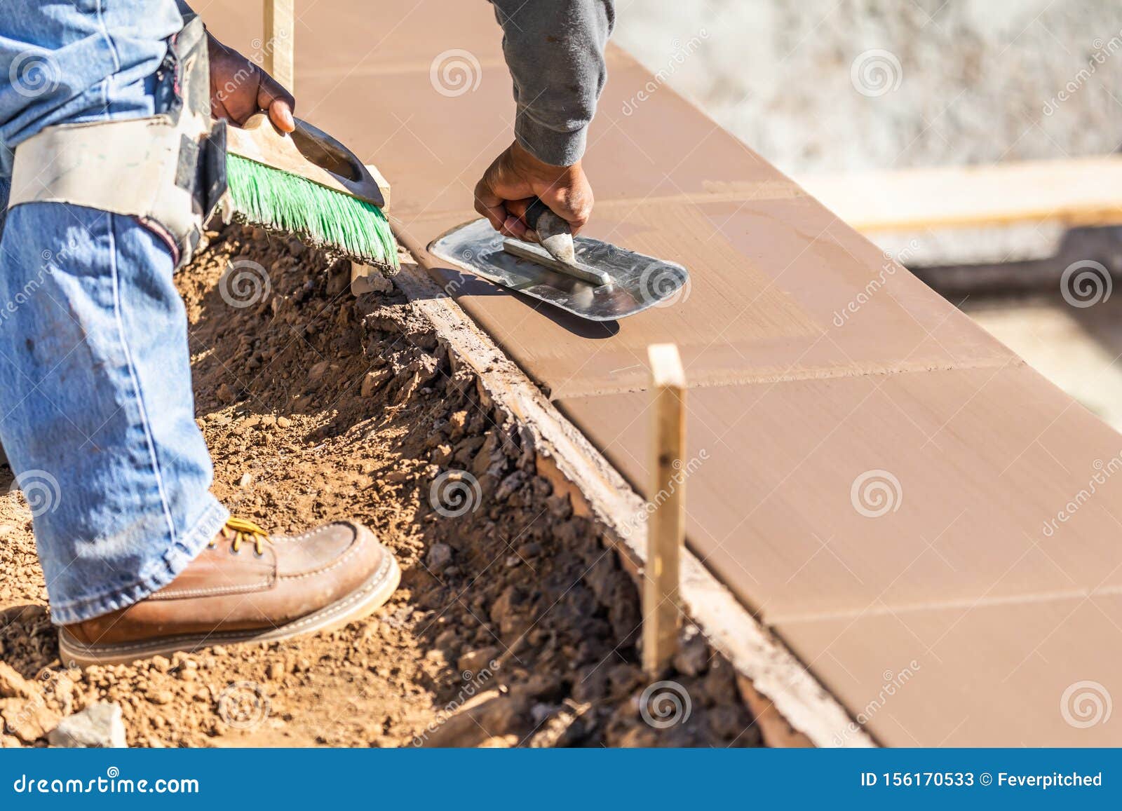 Construction Worker Using Trowel on Wet Cement Forming Coping Around ...