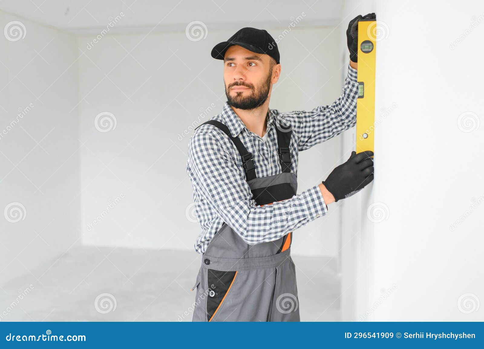 Construction Worker Using a Water Level. Stock Image - Image of home ...