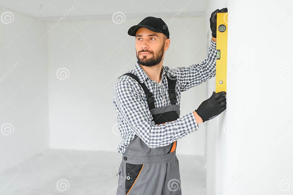 Construction Worker Using a Water Level. Stock Image - Image of home ...