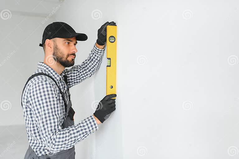 Construction Worker Using a Water Level. Stock Image - Image of ...
