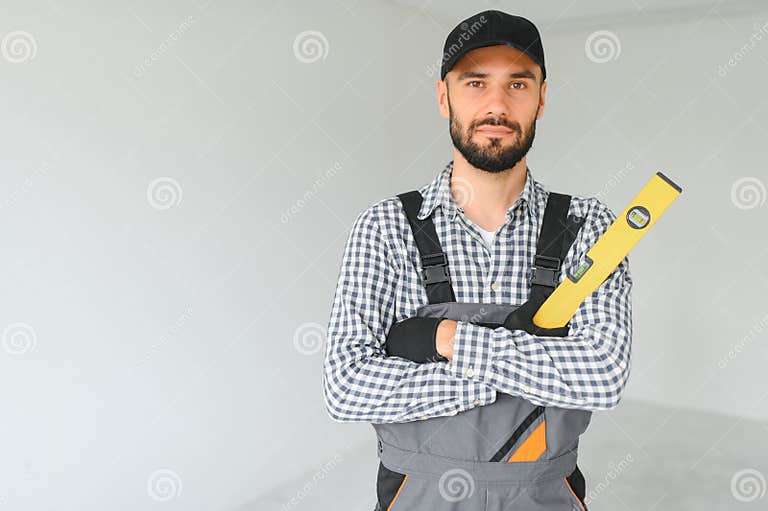 Construction Worker Using a Water Level. Stock Image - Image of male ...