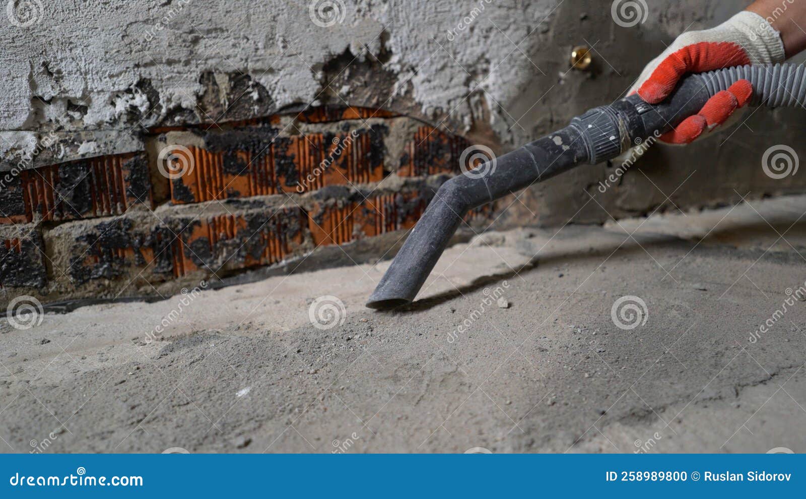 Construction Worker Vacuuming on a Construction Site. a Worker Cleans ...