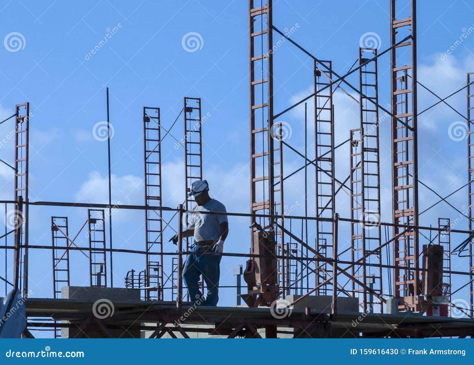Construction Worker Walking on Scaffold Past Numerous Steel Frames ...