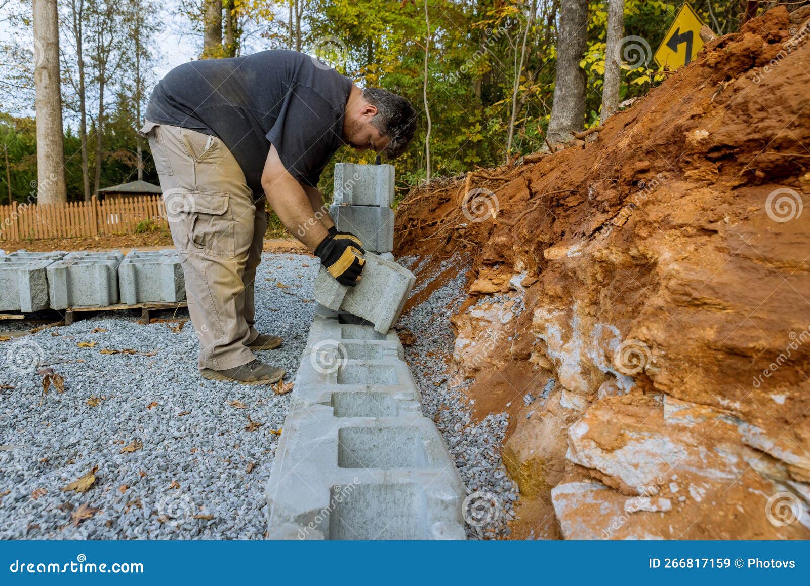 A Construction Worker Was Installing a Concrete Block for a Retaining ...