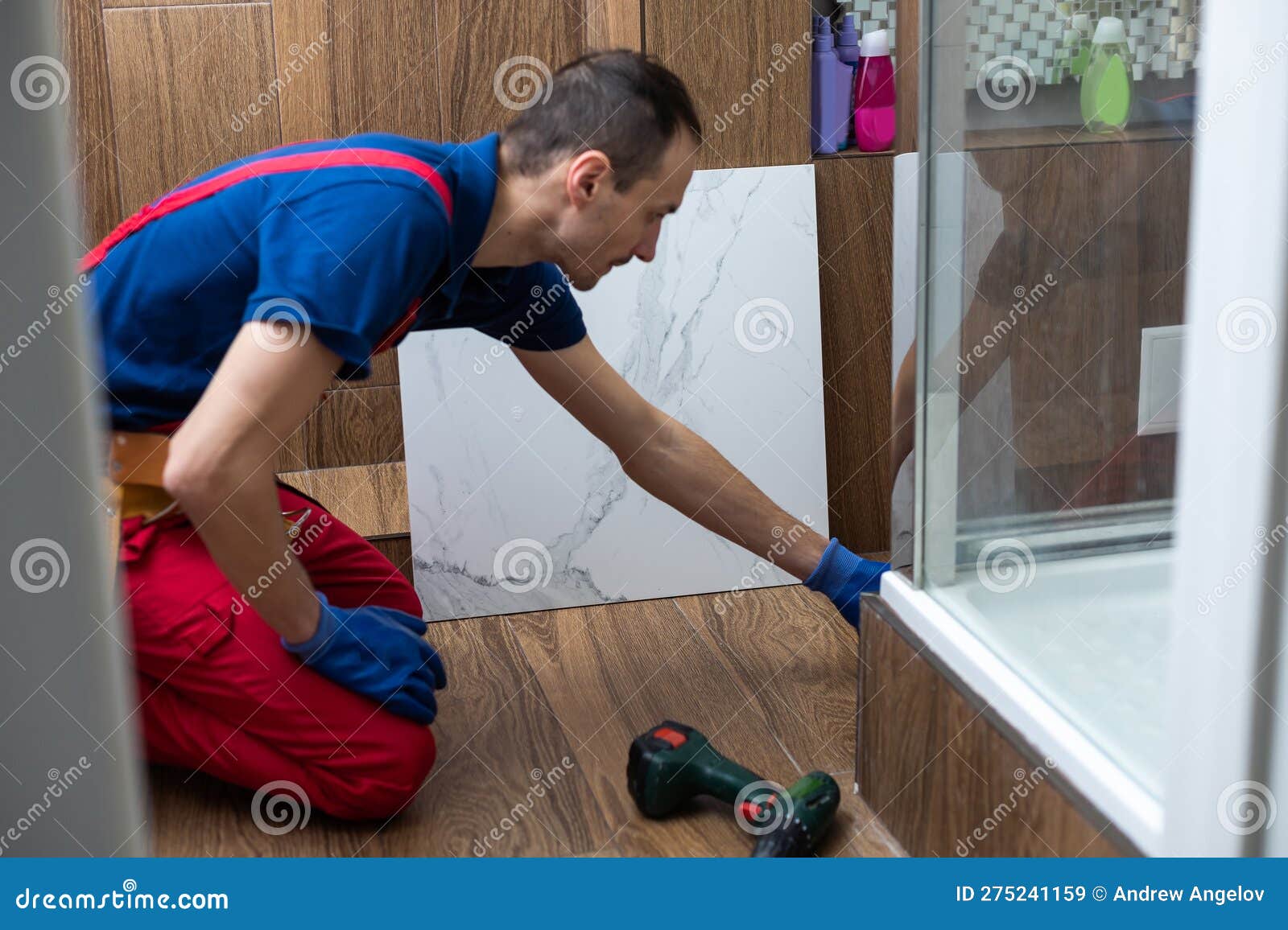 Construction Worker Wearing Bib Overalls and Hard Hat Cutting Ceramic ...