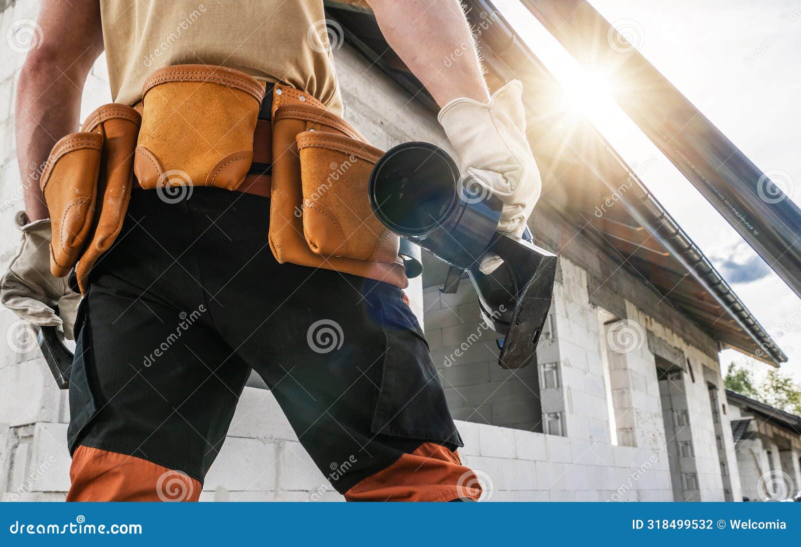 Construction Worker with Tool Belt and Gutter Element in His Hand Stock Photo - Image of blue ...