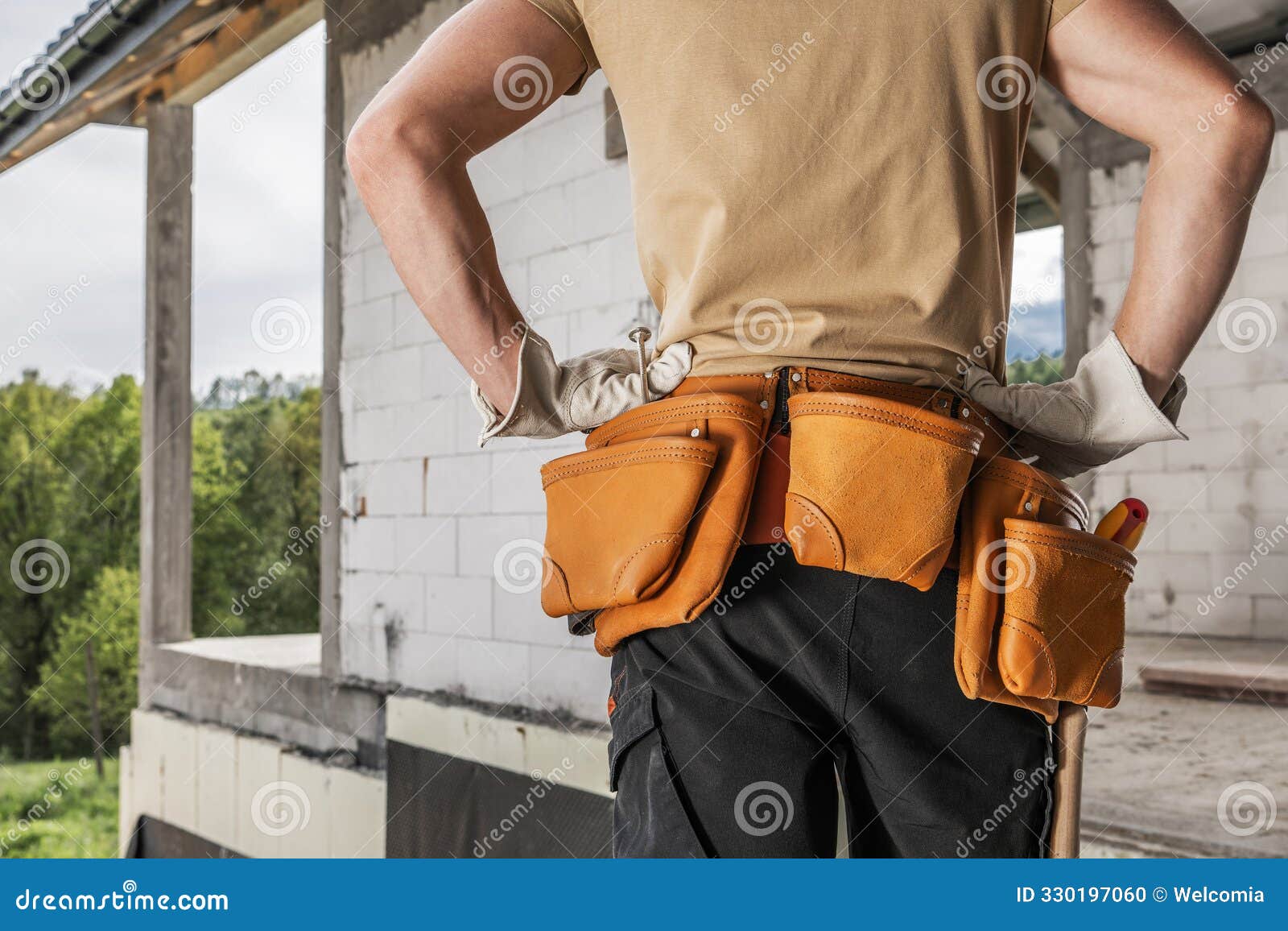 Construction Worker Wearing Tools Belt at a Building Site during ...