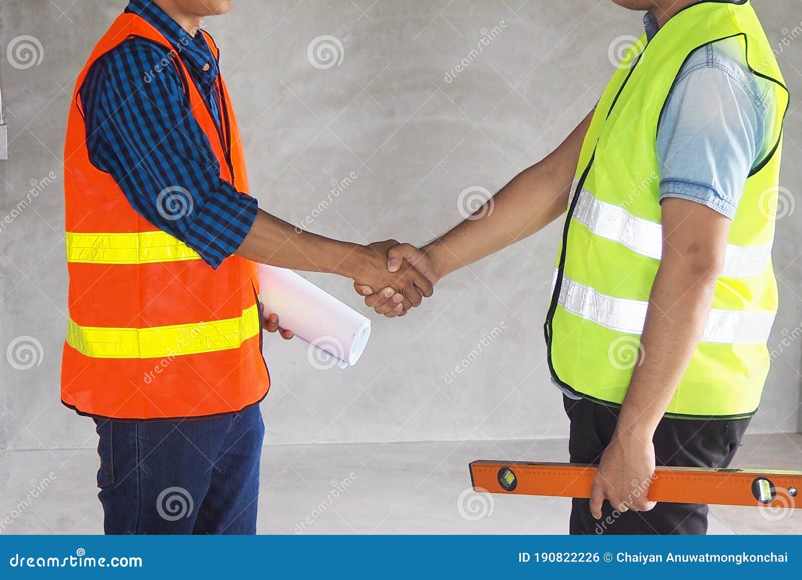 Construction Worker Wearing a Vest is Holding Hands while Working on a ...