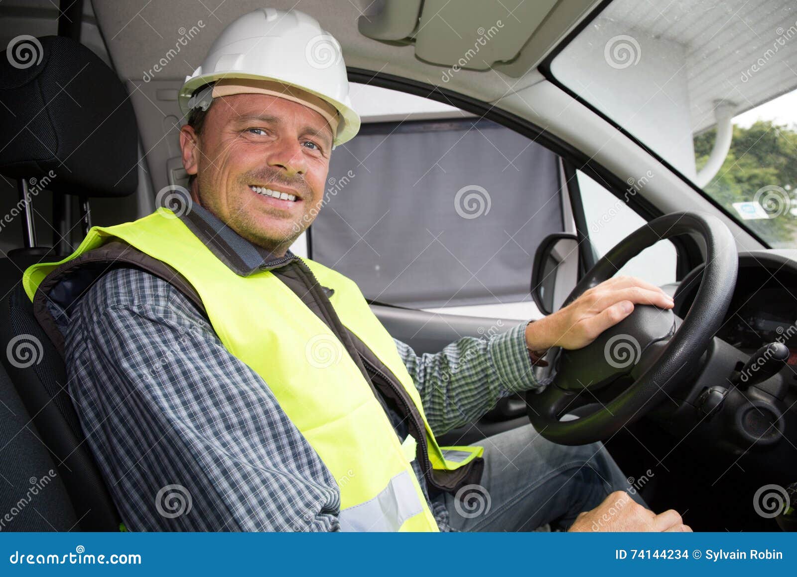 Construction Worker, Wearing a White Helmet in a Car Driving Stock ...