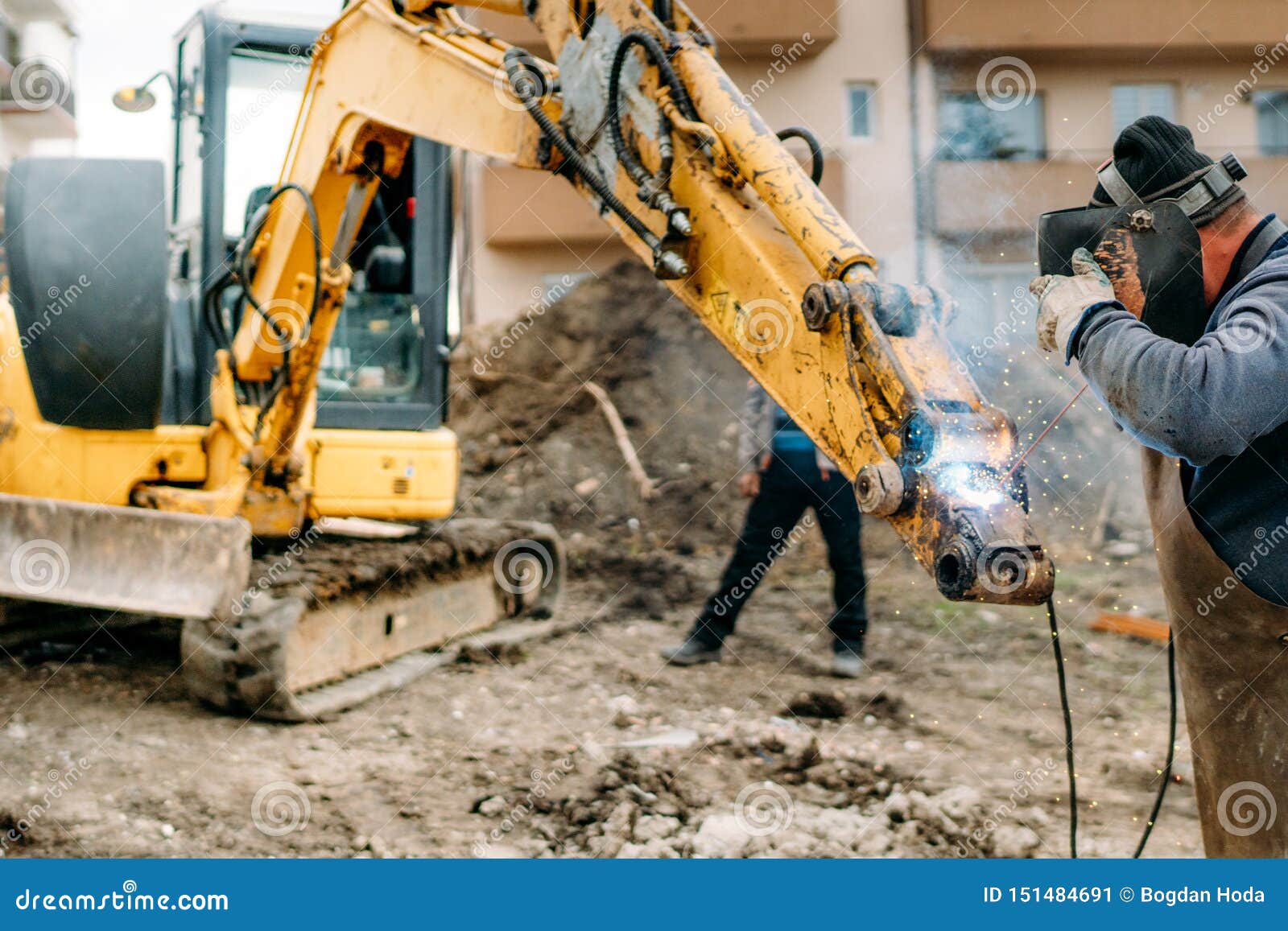 Worker Welding Broken Excavator on Construction Site Stock Image ...