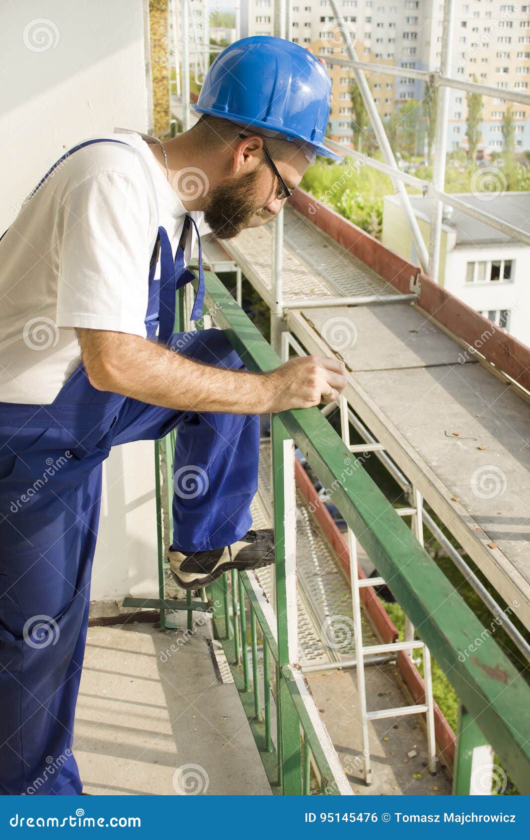 Construction Worker in a Work Attire Holds a Construction Helmet ...