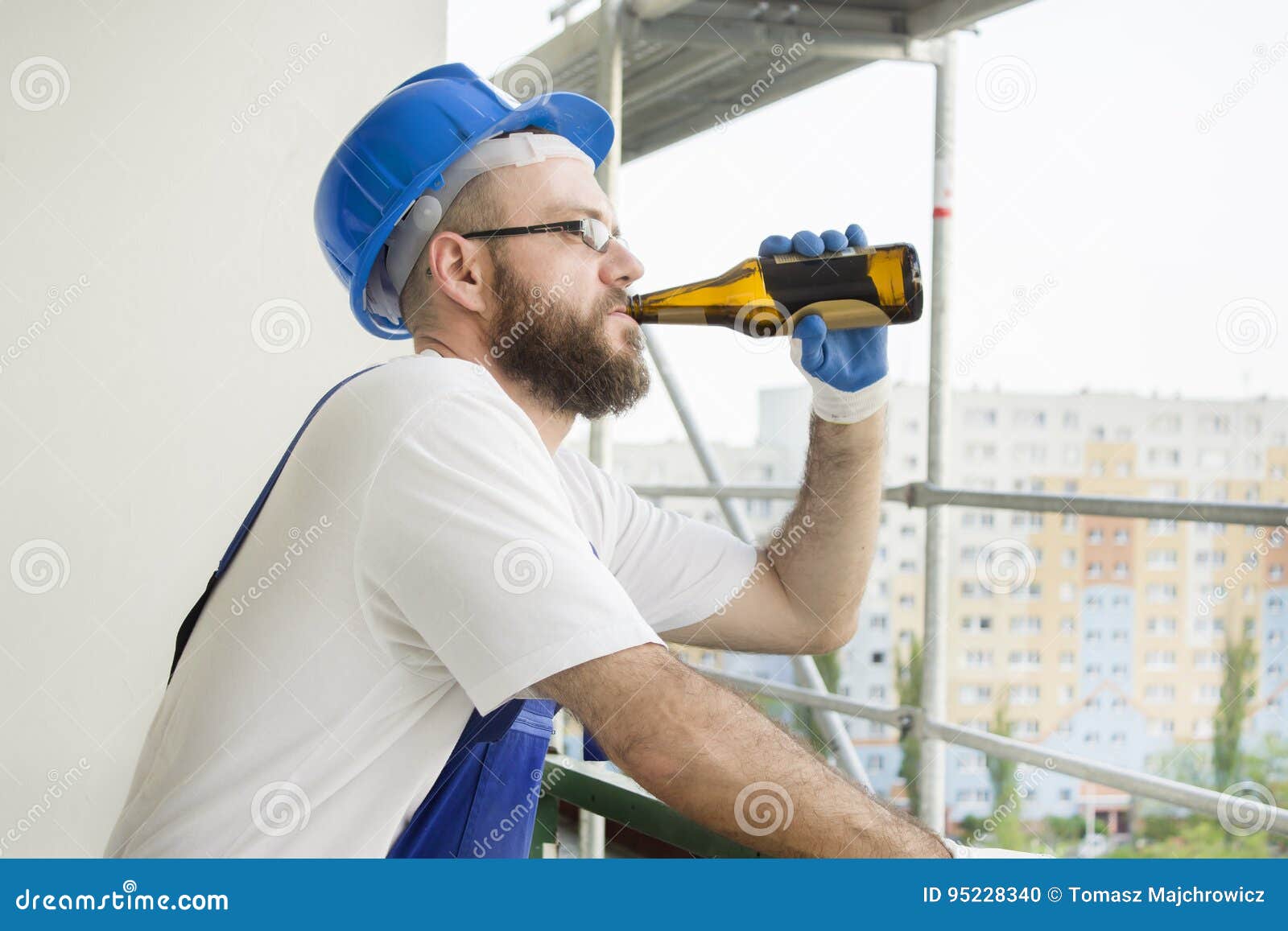 Construction Worker in Work Wear, Protective Gloves and a Helmet on the ...