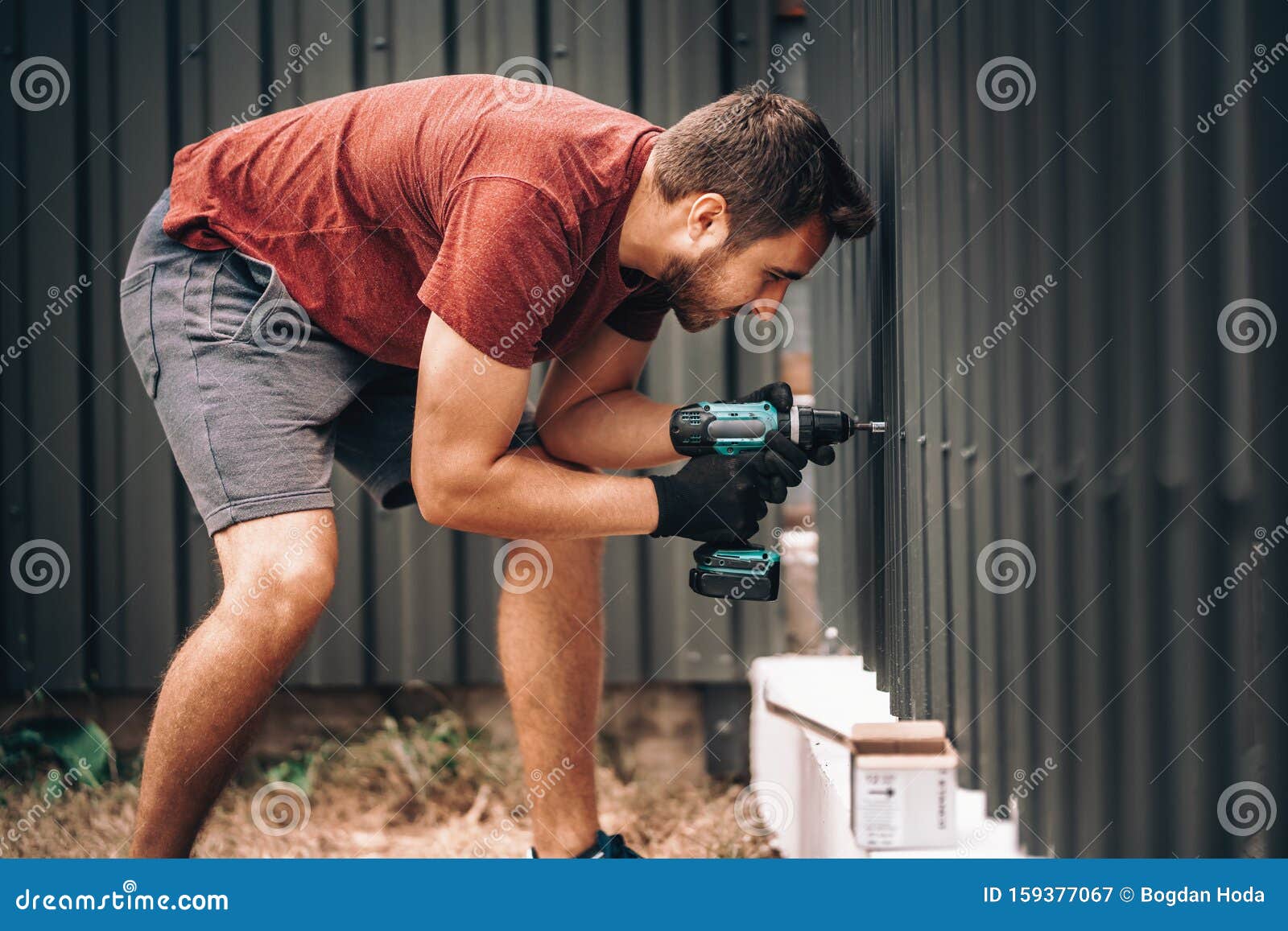 Construction Worker Working with Cordless Screwdriver Fastening Screws ...