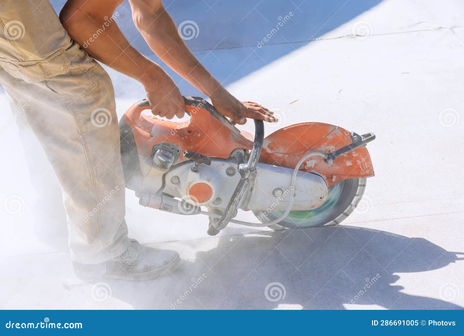 Construction Worker with Working Diamond Blade Saw To Cut Off Concrete ...