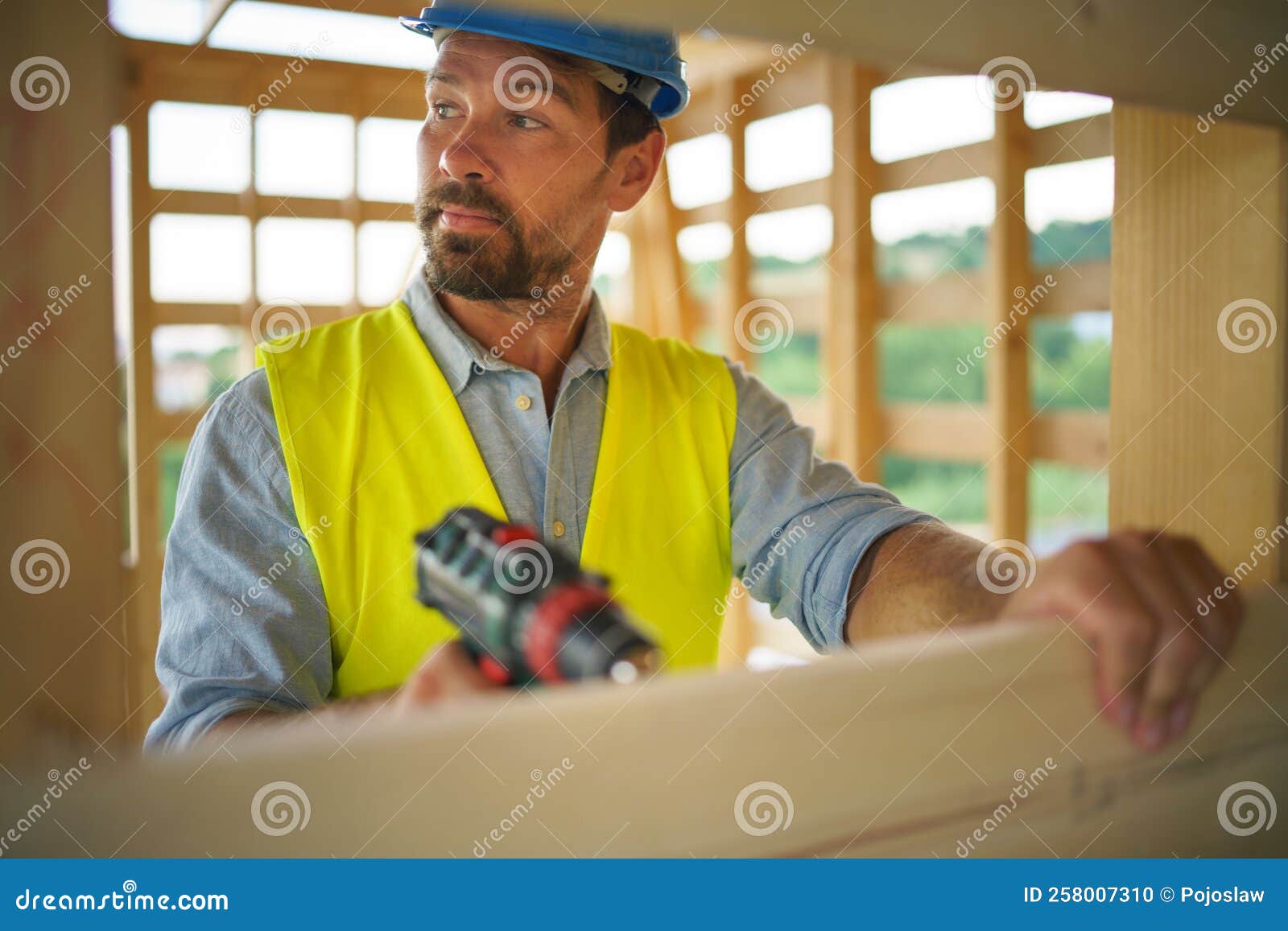 Construction Worker Working with Electric Screwdriver on Wooden Frame ...