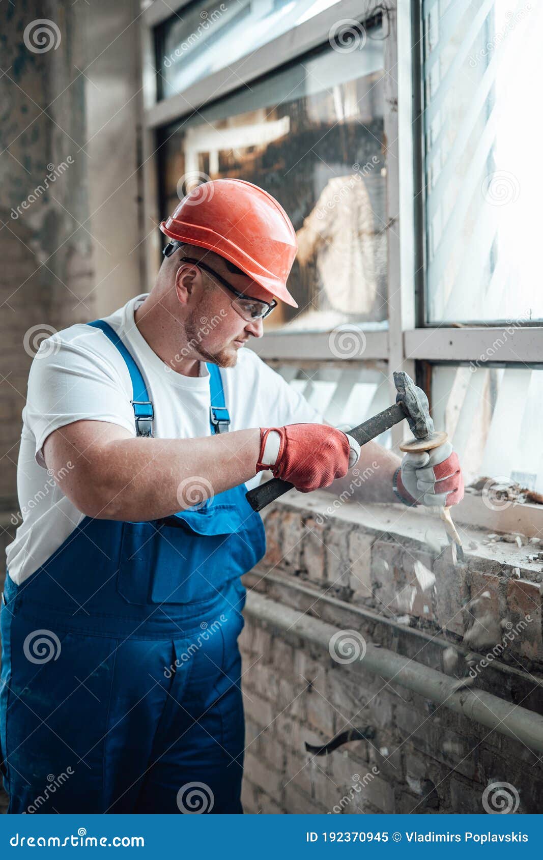 Construction Worker Working with a Hammer, Destroying Old Brick Walls ...