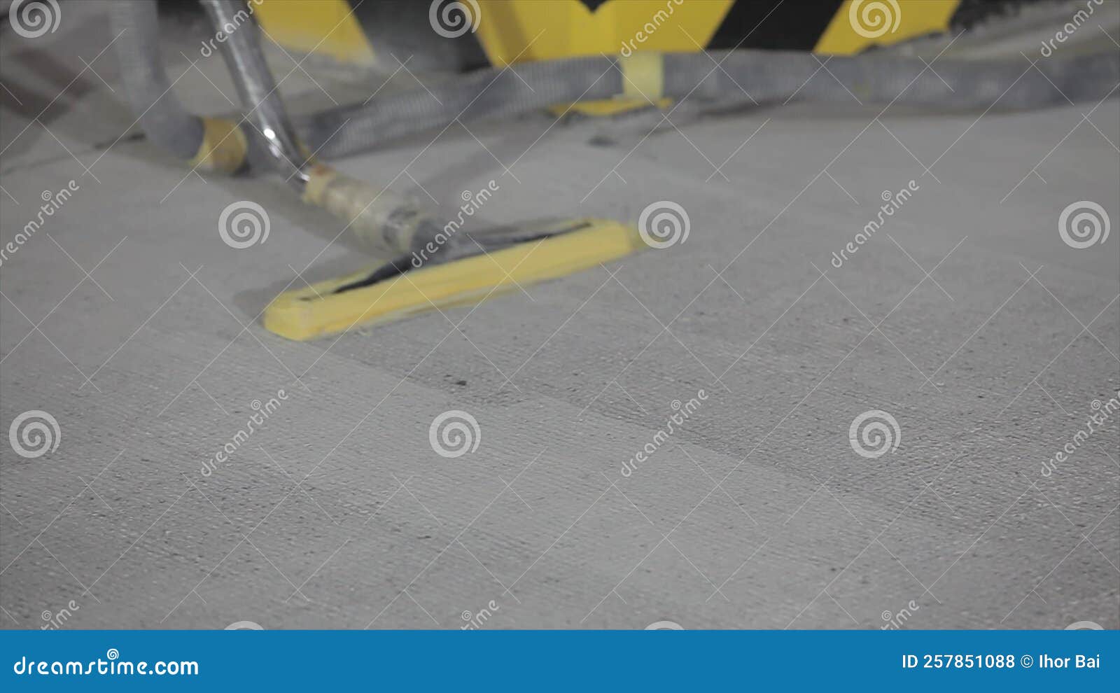 The Construction Worker Works As a Vacuum Cleaner. Cleaning the Surface ...