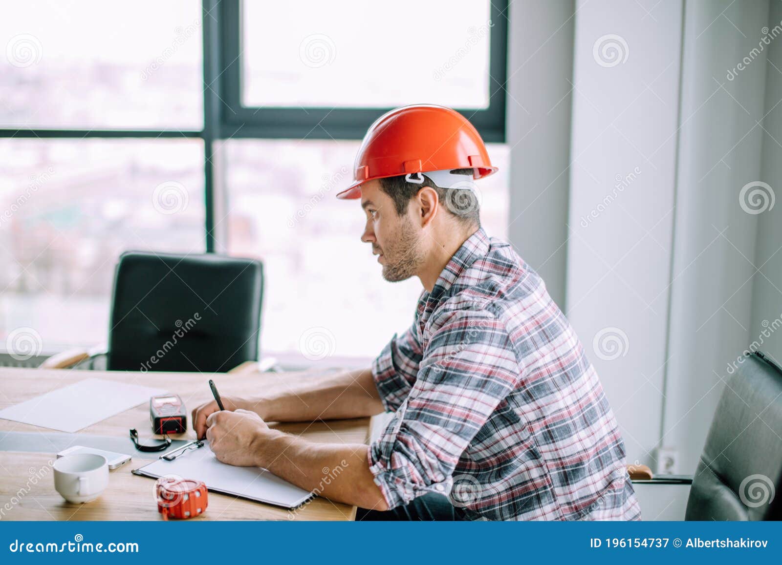 Construction Worker is Writing the Length and Wideth of the Model Stock ...