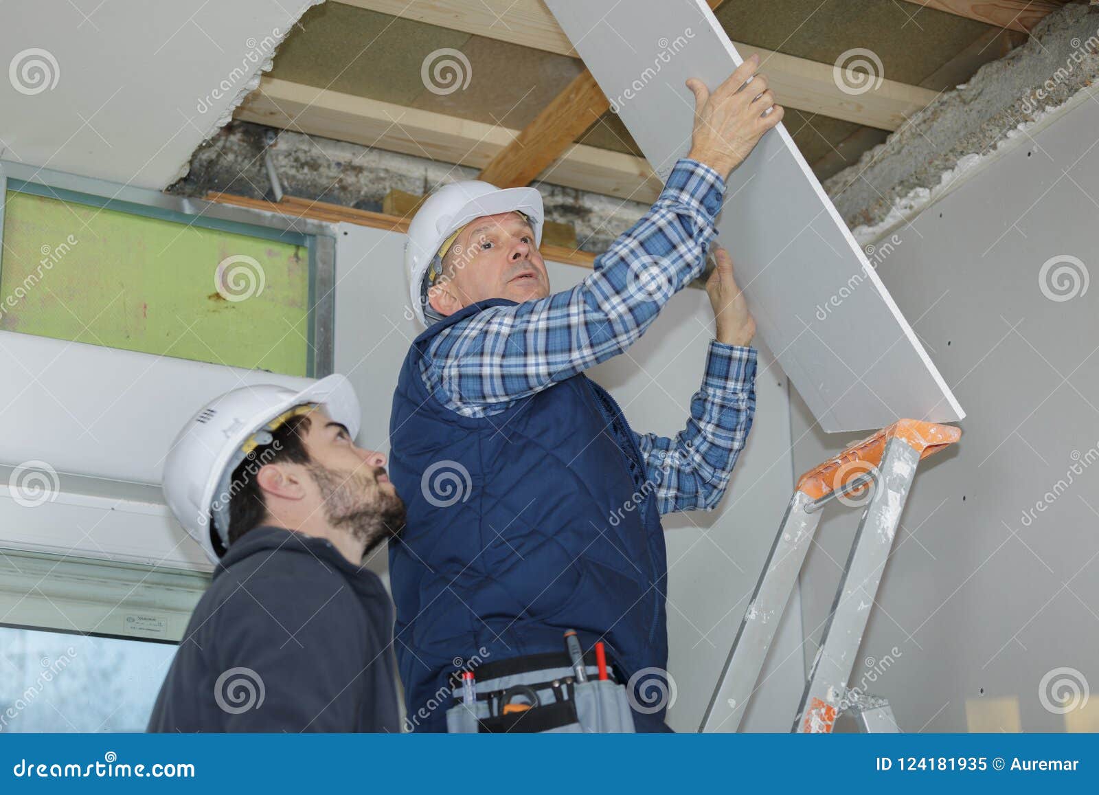 Construction Workers Adjusting Ceiling Panels Stock Image - Image of ...