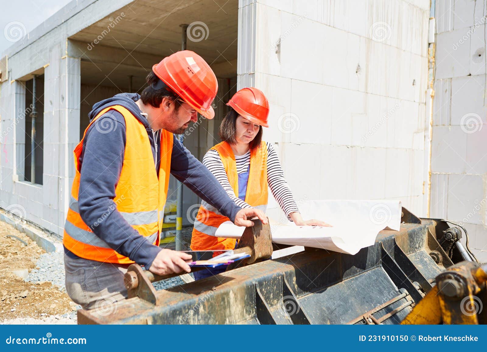 Construction Workers and Architect Discuss Construction Project Stock ...