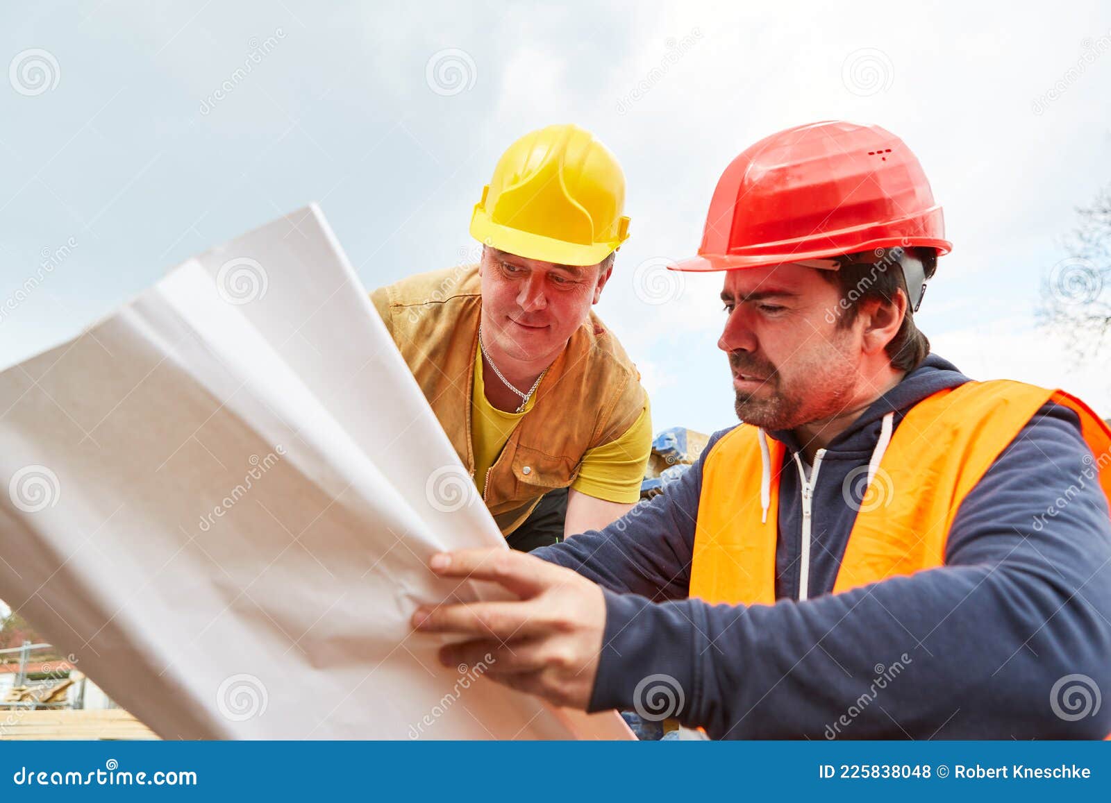 Construction Workers and Architect Look at Construction Drawing Stock ...