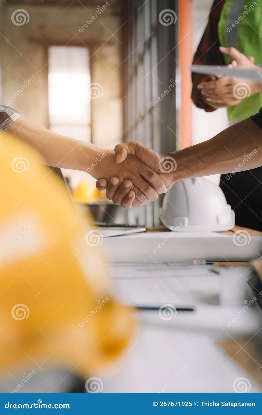 Construction Workers, Architects and Engineers Shake Hands while ...