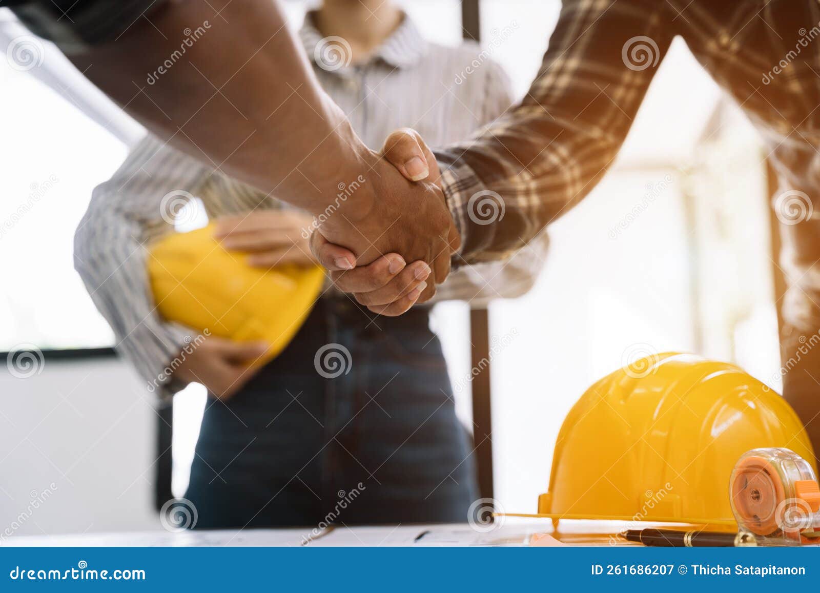 Construction Workers, Architects And Engineers Shake Hands While ...
