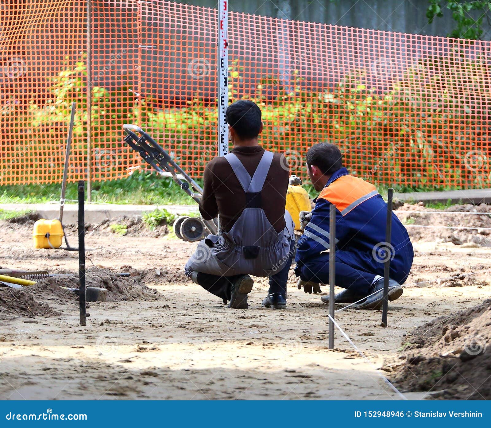 Construction Workers with a Benchmark Editorial Photo - Image of summer ...