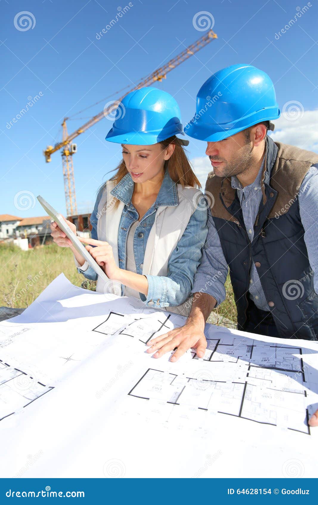 Construction Workers with Blueprint Stock Photo - Image of helmet ...