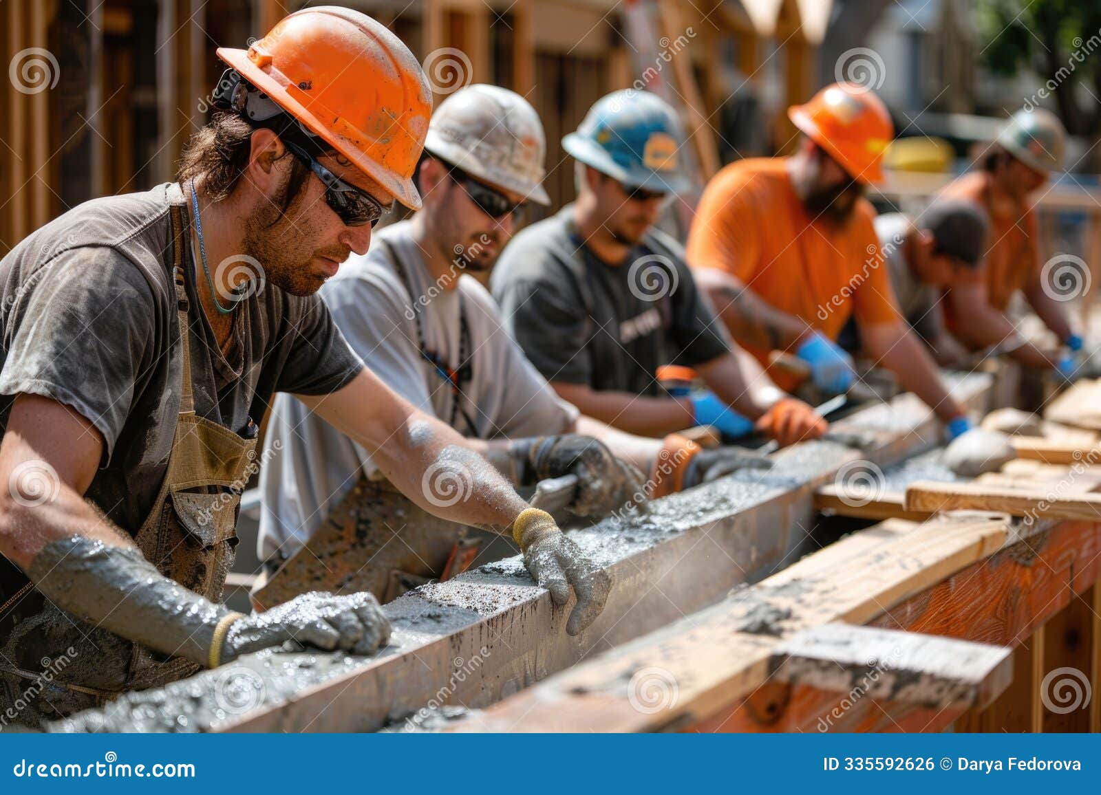 Construction Workers Building Wooden Framework on Site with Safety Gear ...