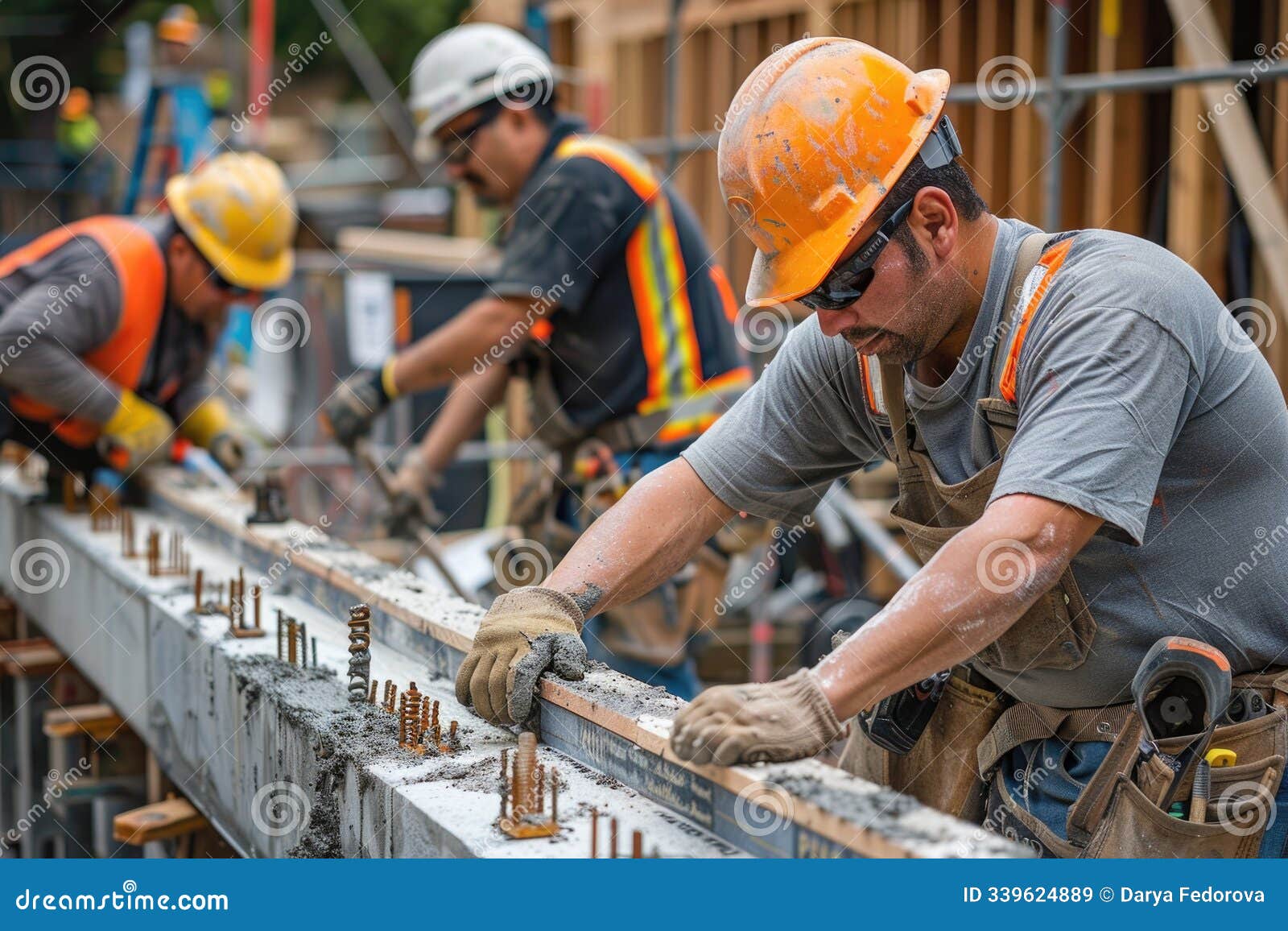 Construction Workers Building Wooden Framework on Site with Safety Gear ...